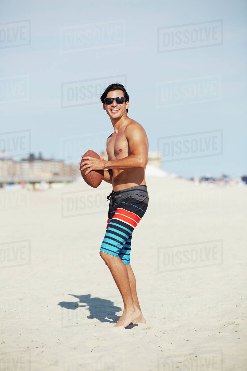 Man playing with football on beach - Royalty-free Stock Photo | Dissolve