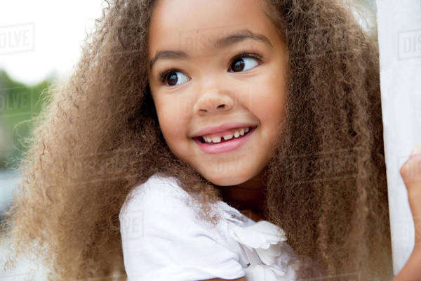 Mixed race girl smiling - Royalty-free Stock Photo | Dissolve