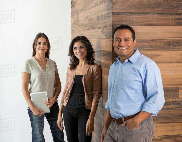 Business people smiling in office - Stock Photo - Dissolve