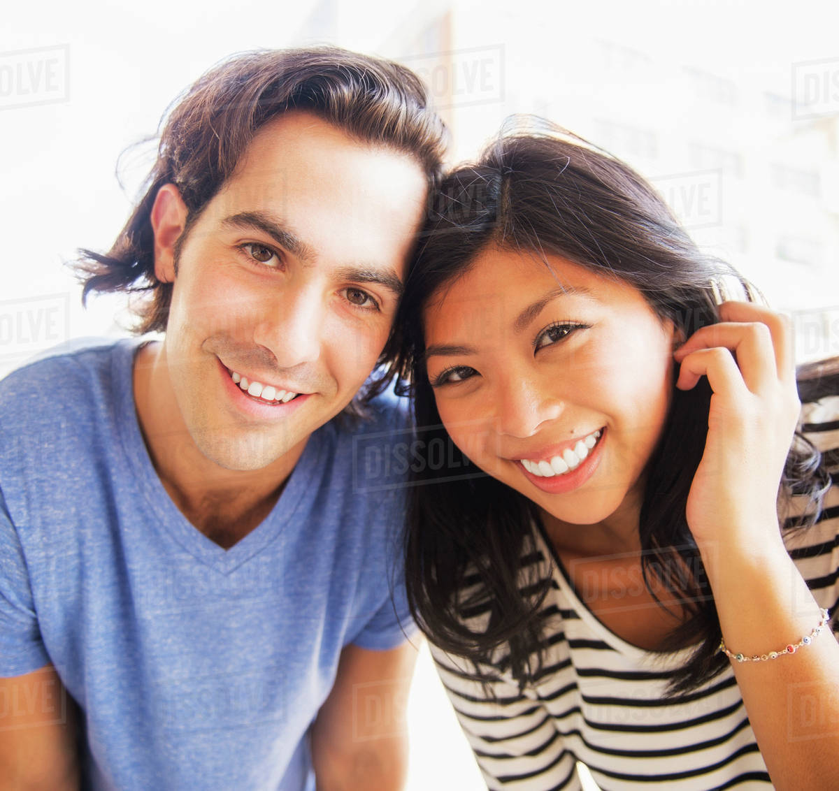 Couple smiling together outdoors - Royalty-free Stock Photo | Dissolve
