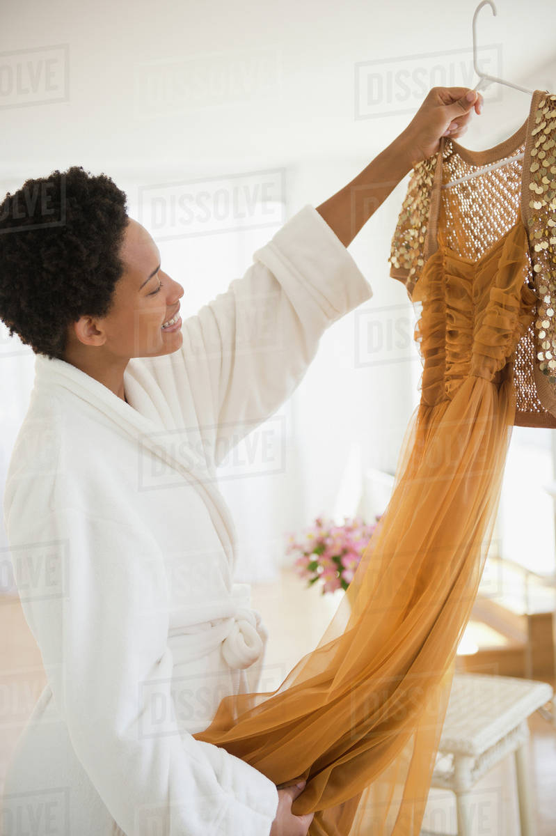 African American woman holding up glamorous dress - Royalty-free Stock ...