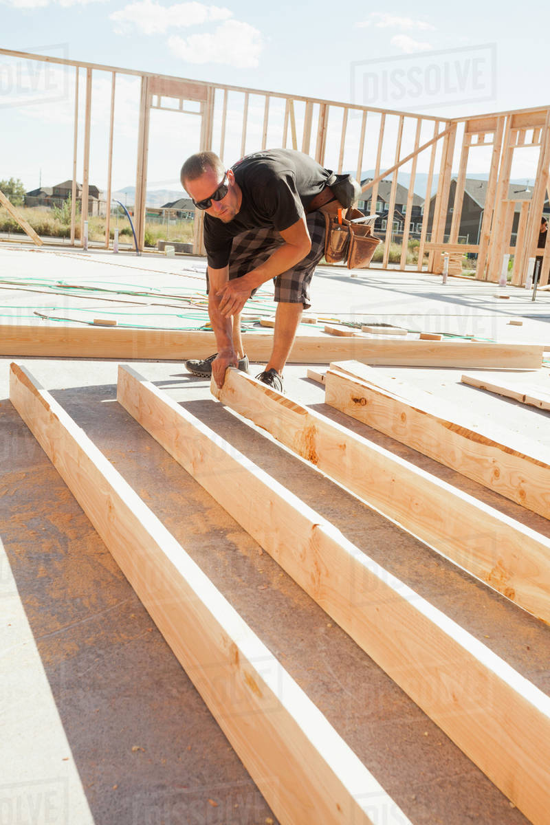 Caucasian man lifting frame on construction site - Royalty-free Stock ...