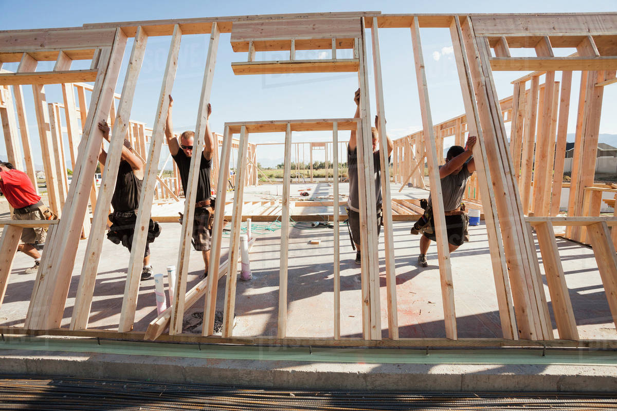 Workers lifting frame on construction site - Royalty-free Stock Photo ...
