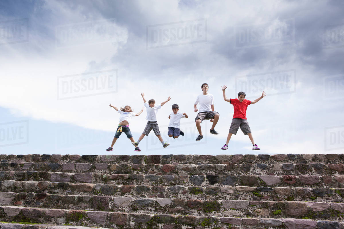 Children jumping on top of steps - Royalty-free Stock Photo | Dissolve