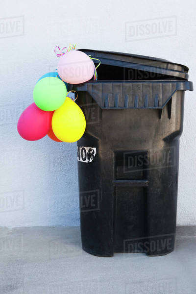 Bunch of balloons in garbage can - Royalty-free Stock Photo | Dissolve