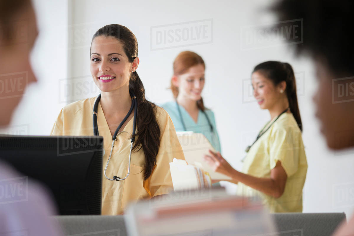 Nurses in colorful scrubs talking in hospital - Stock Photo - Dissolve