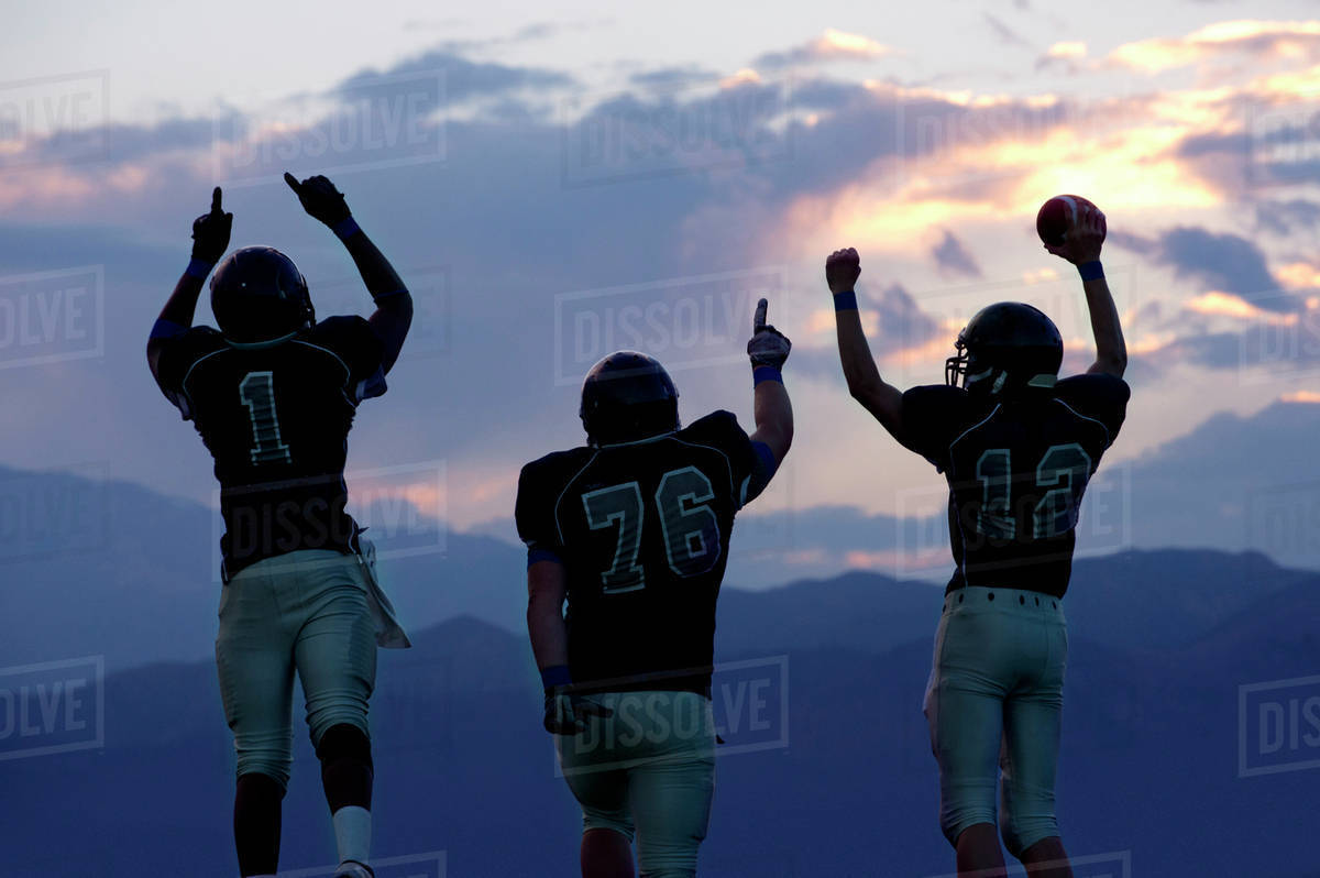 Football players cheering in game - Stock Photo - Dissolve