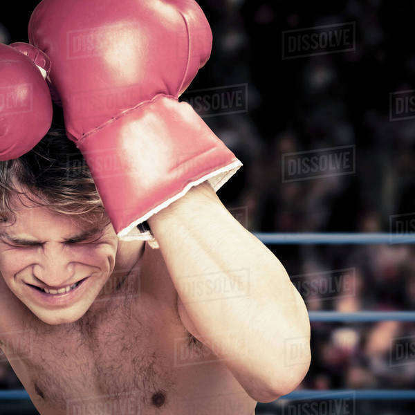 Caucasian boxer covering his head - Stock Photo - Dissolve