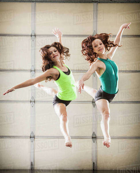 Dancers leaping in studio - Royalty-free Stock Photo | Dissolve