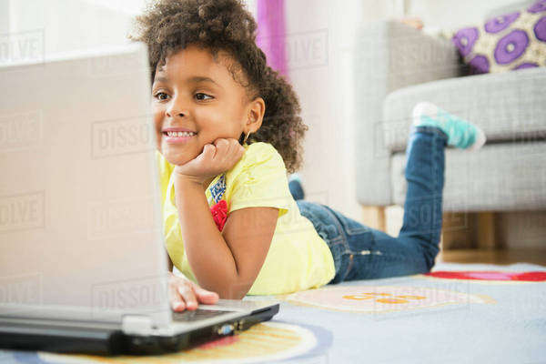 African American girl using laptop on floor - Royalty-free Stock Photo ...