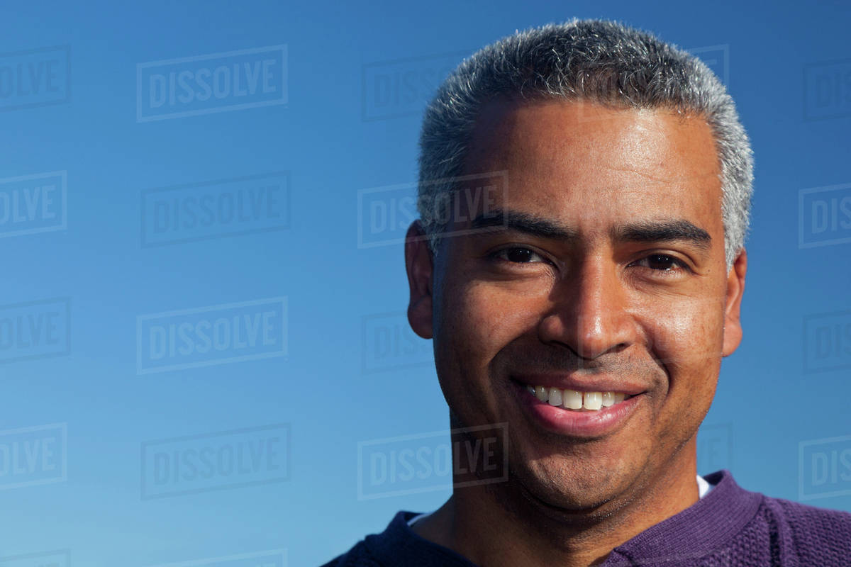 Hispanic man smiling outdoors - Royalty-free Stock Photo | Dissolve
