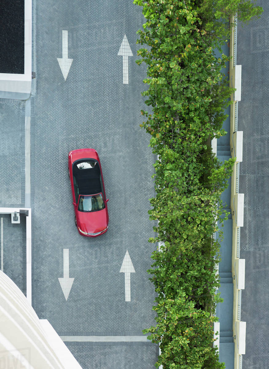 Aerial view of car driving on street with arrows - Royalty-free Stock ...