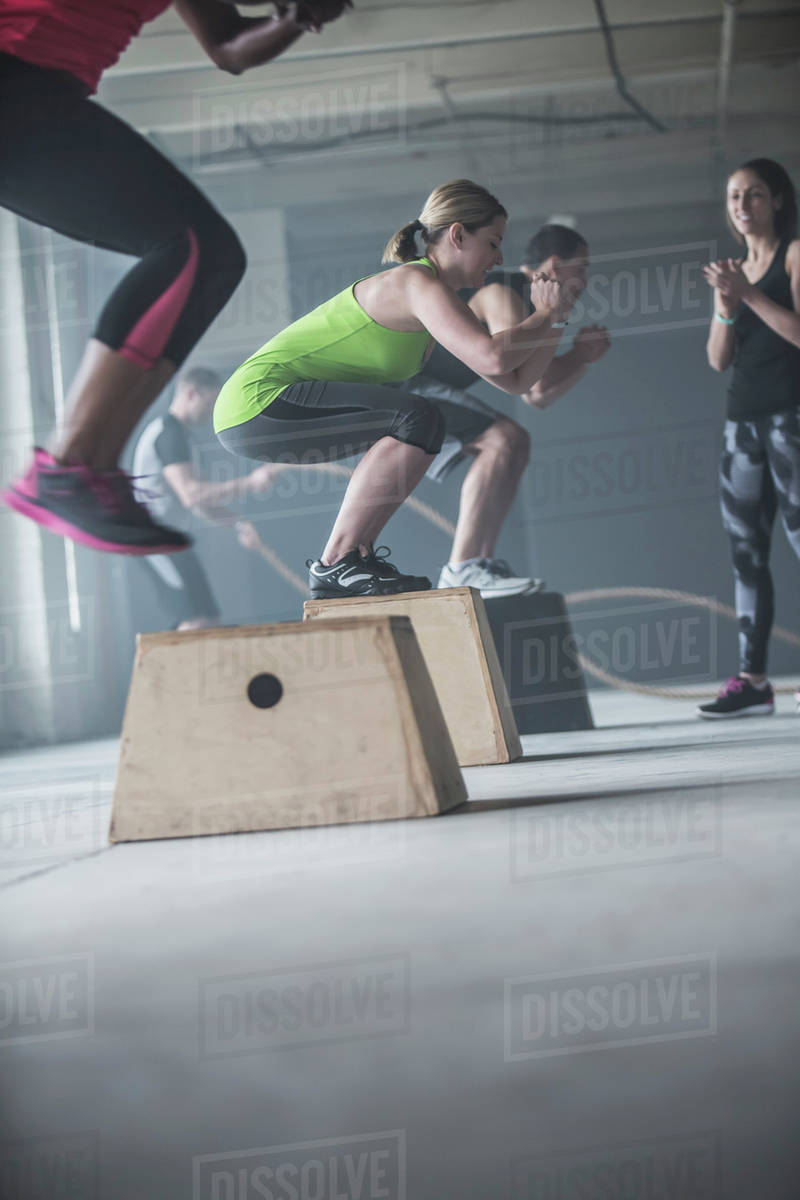 Athletes jumping on platforms in gym - Stock Photo - Dissolve