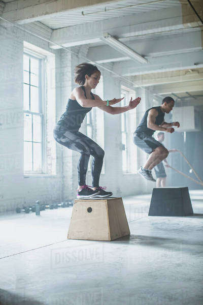 Athletes jumping on platforms in gym - Royalty-free Stock Photo | Dissolve
