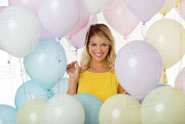 Caucasian woman standing with balloons - Royalty-free Stock Photo ...