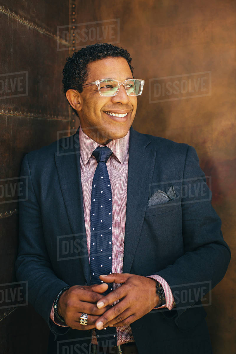 Mixed race businessman smiling - Stock Photo - Dissolve