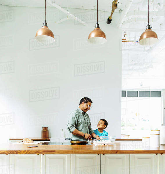 Father and son cooking in kitchen - Royalty-free Stock Photo | Dissolve