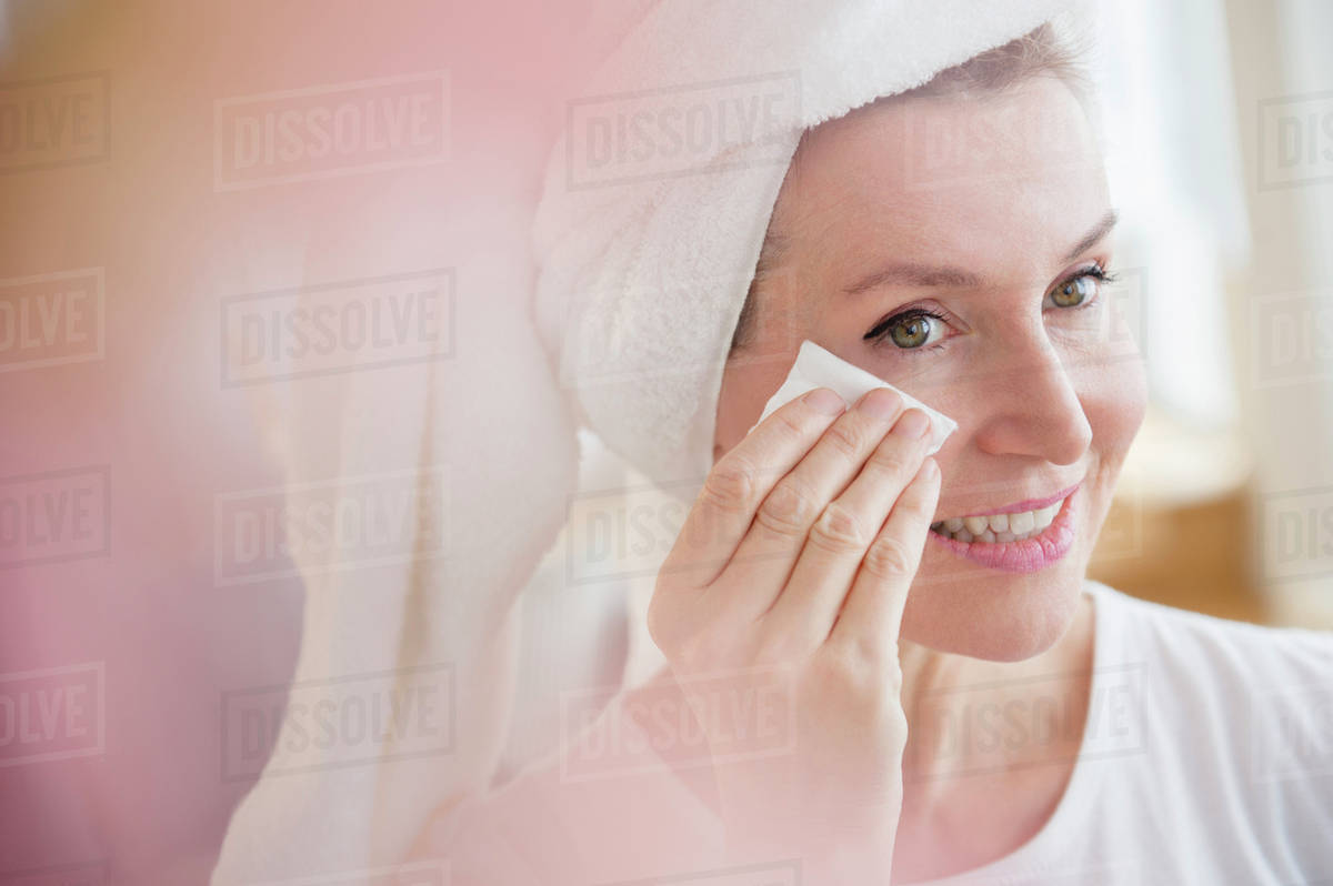 Caucasian woman wiping face - Royalty-free Stock Photo | Dissolve