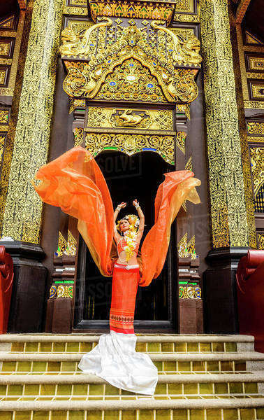 Asian woman standing on ornate temple stairs, Chiang Mai, Chiang Mai ...