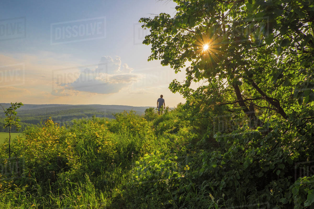 Mari man walking in rural landscape - Stock Photo - Dissolve
