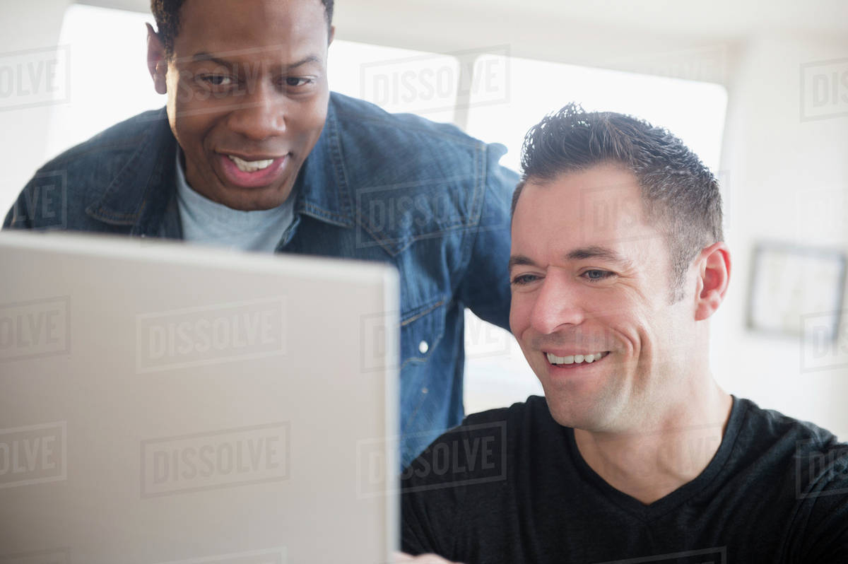 Men using computer in office - Stock Photo - Dissolve