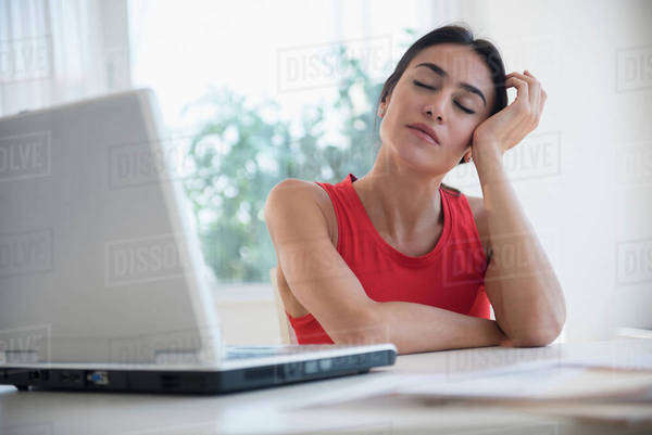 Stressed businesswoman sitting at laptop at desk - Royalty-free Stock ...