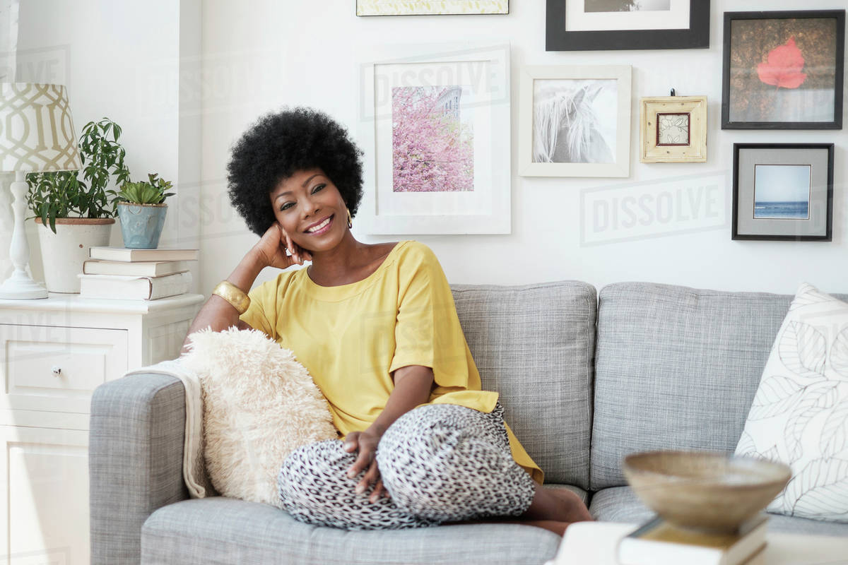 African American woman relaxing on sofa - Royalty-free Stock Photo ...