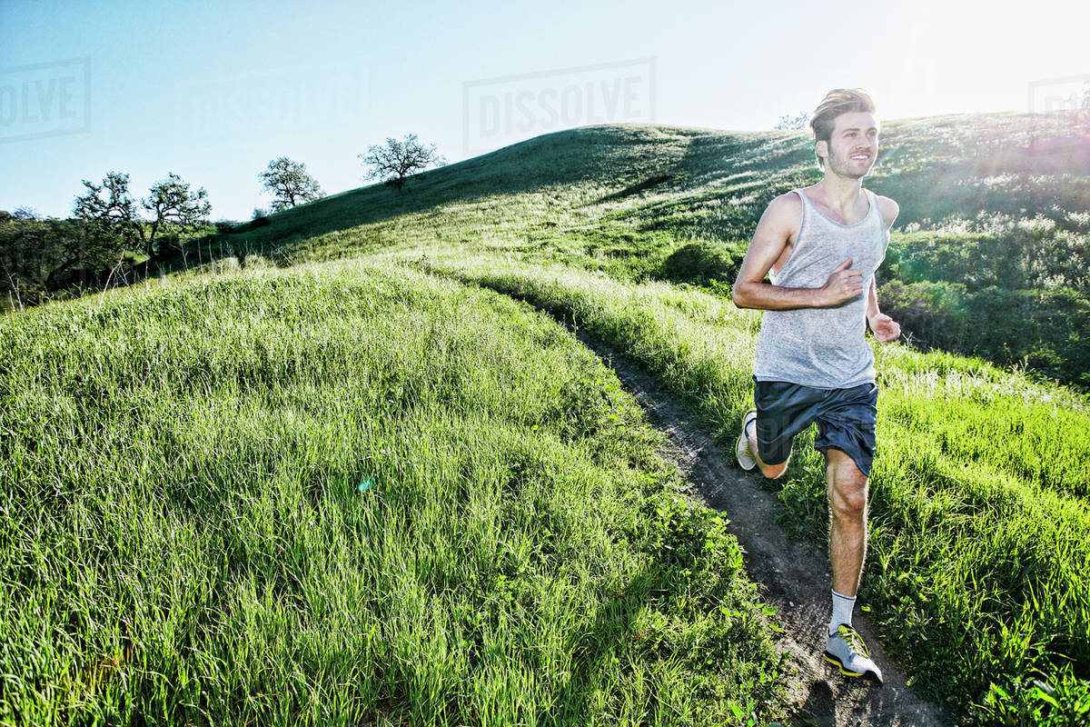 Caucasian athlete running on rural trail - Royalty-free Stock Photo ...