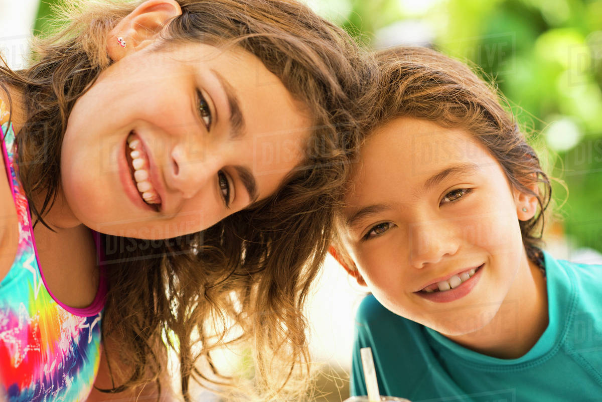 Close up of sisters smiling - Royalty-free Stock Photo | Dissolve
