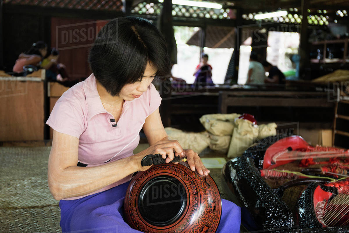 Asian artisan carving traditional design in workshop - Stock Photo ...