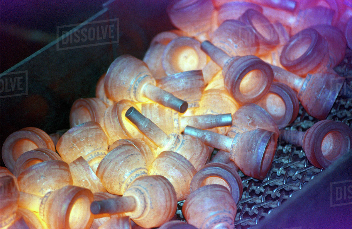 Glowing metal manufactured pieces on conveyor belt - Royalty-free Stock ...