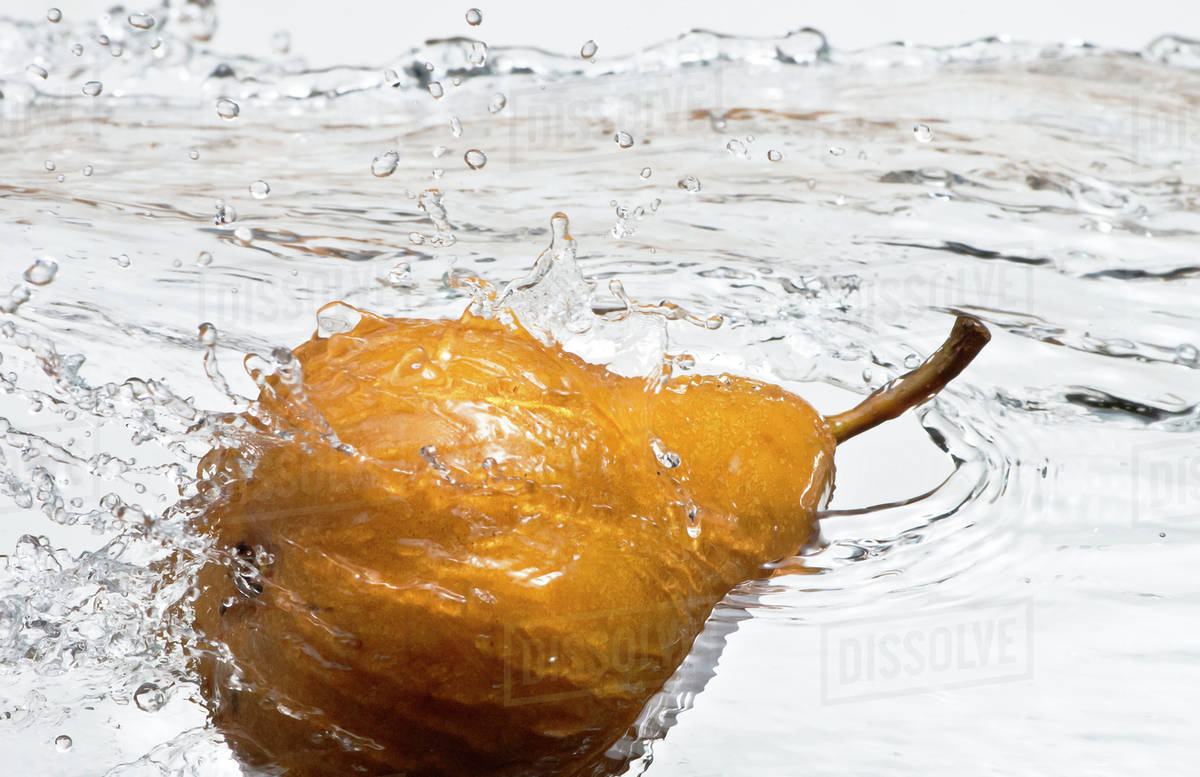 Close up of pear splashing in water - Royalty-free Stock Photo | Dissolve