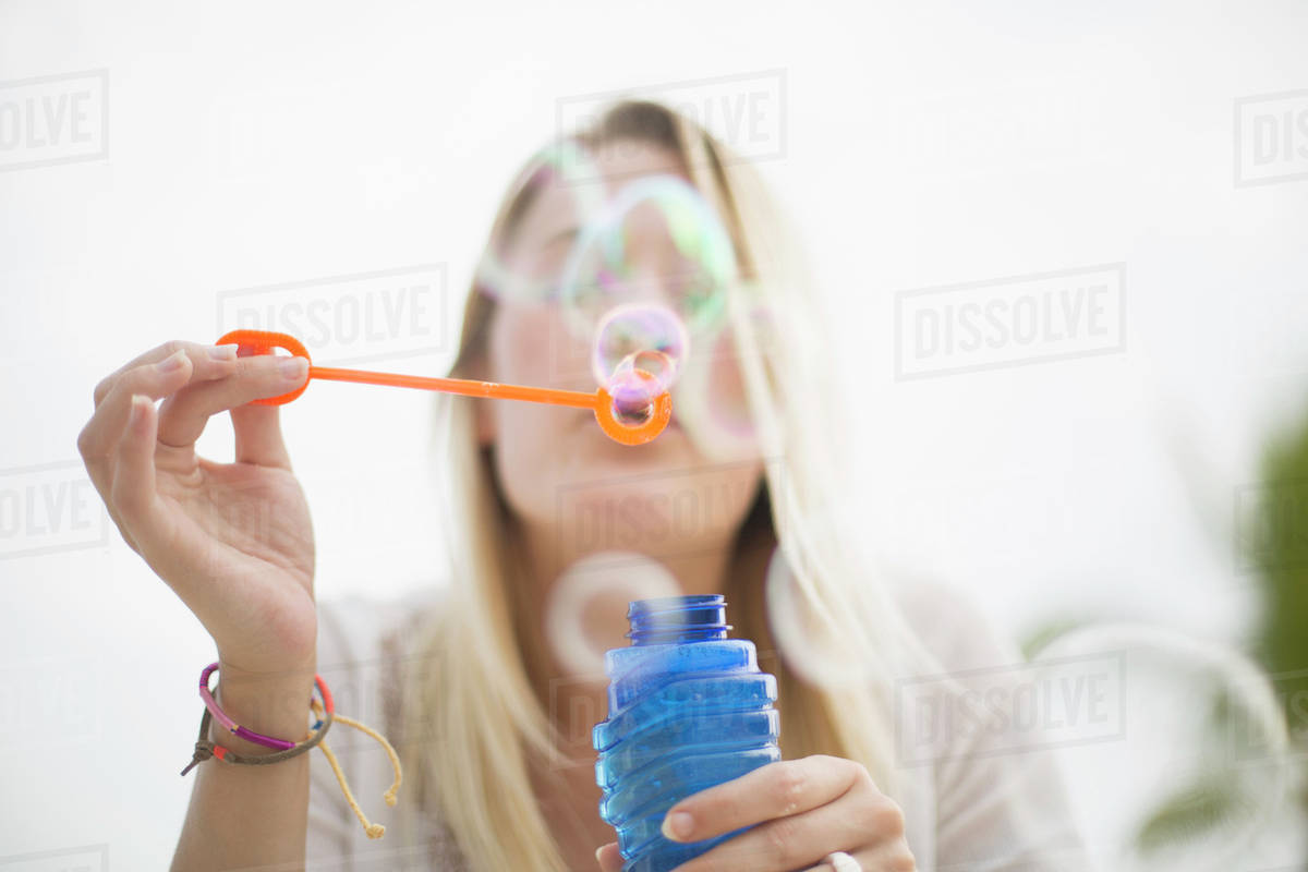 Caucasian woman blowing bubbles outdoors - Royalty-free Stock Photo ...