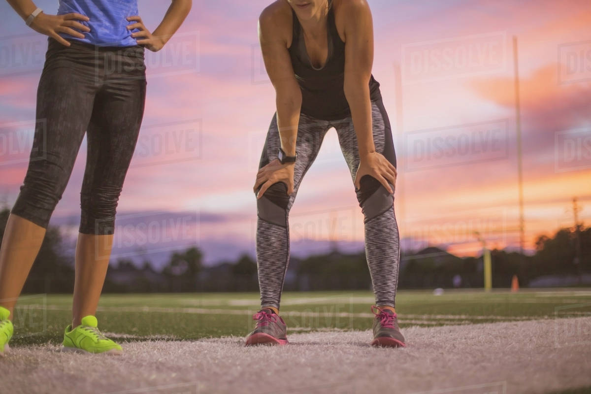 Athletes resting on sports field - Royalty-free Stock Photo | Dissolve