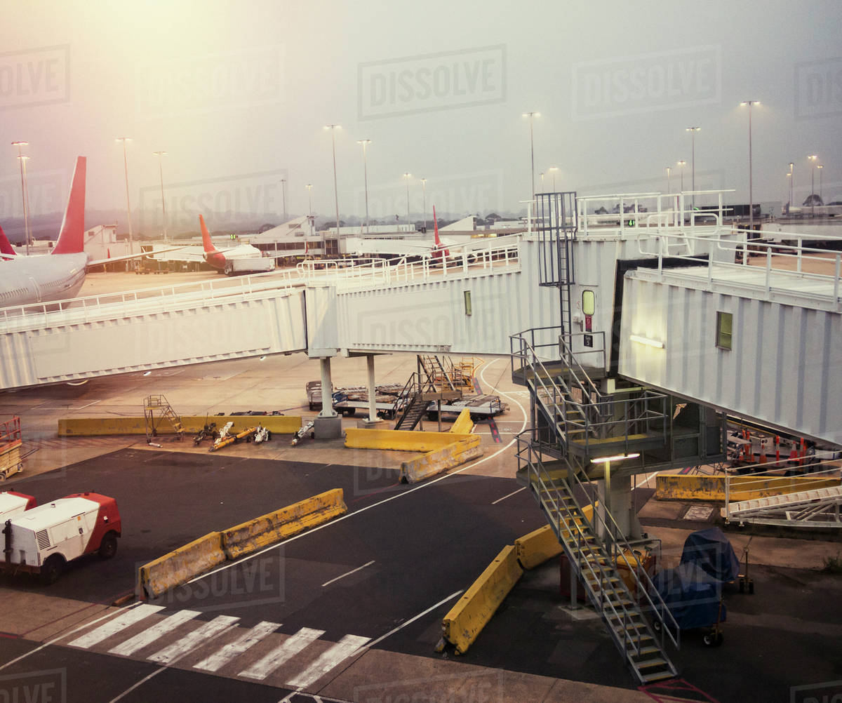 Airplane and elevated walkway on airport runway - Royalty-free Stock ...