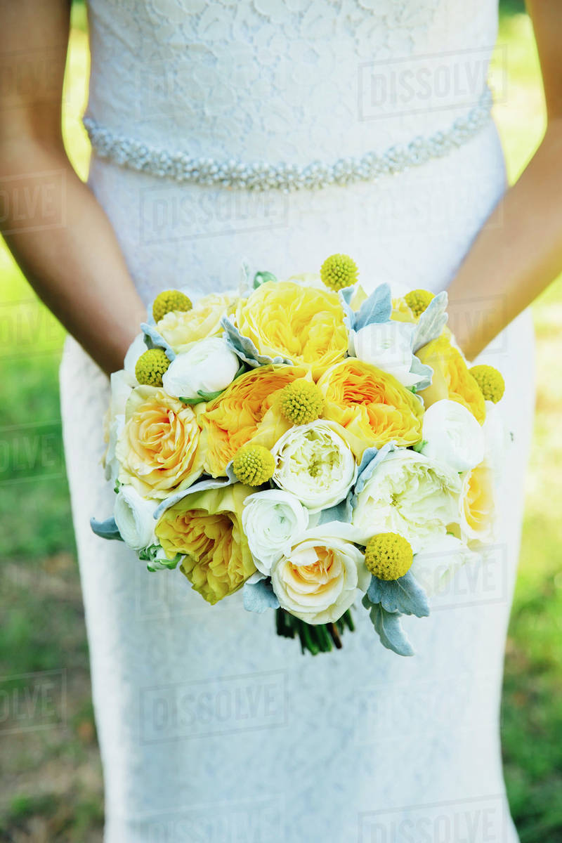 Caucasian bride holding bouquet outdoors - Royalty-free Stock Photo ...