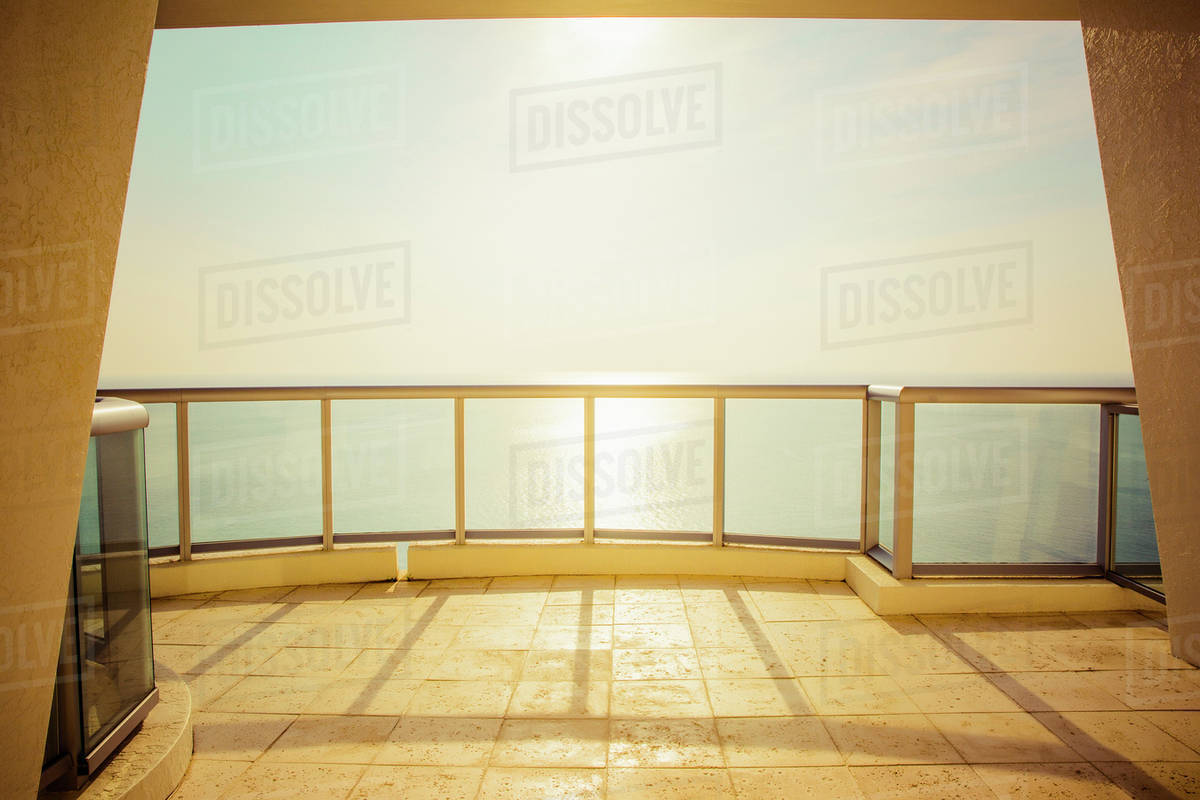 Balcony overlooking ocean and sunny sky - Stock Photo - Dissolve