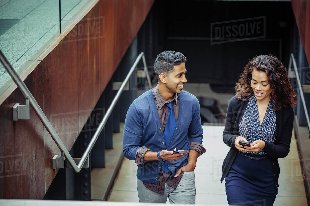 Business people using cell phones on office steps - Royalty-free Stock ...