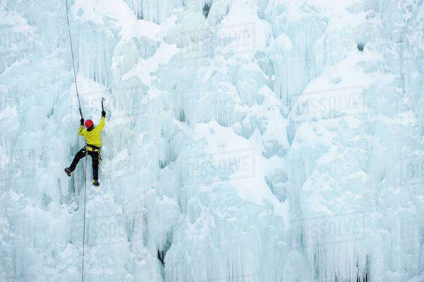 Caucasian man climbing ice - Stock Photo - Dissolve