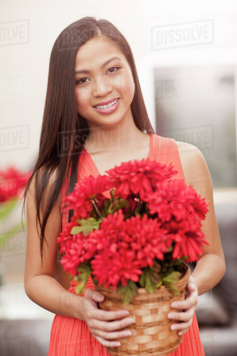Pacific Islander woman holding flowers - Royalty-free Stock Photo ...