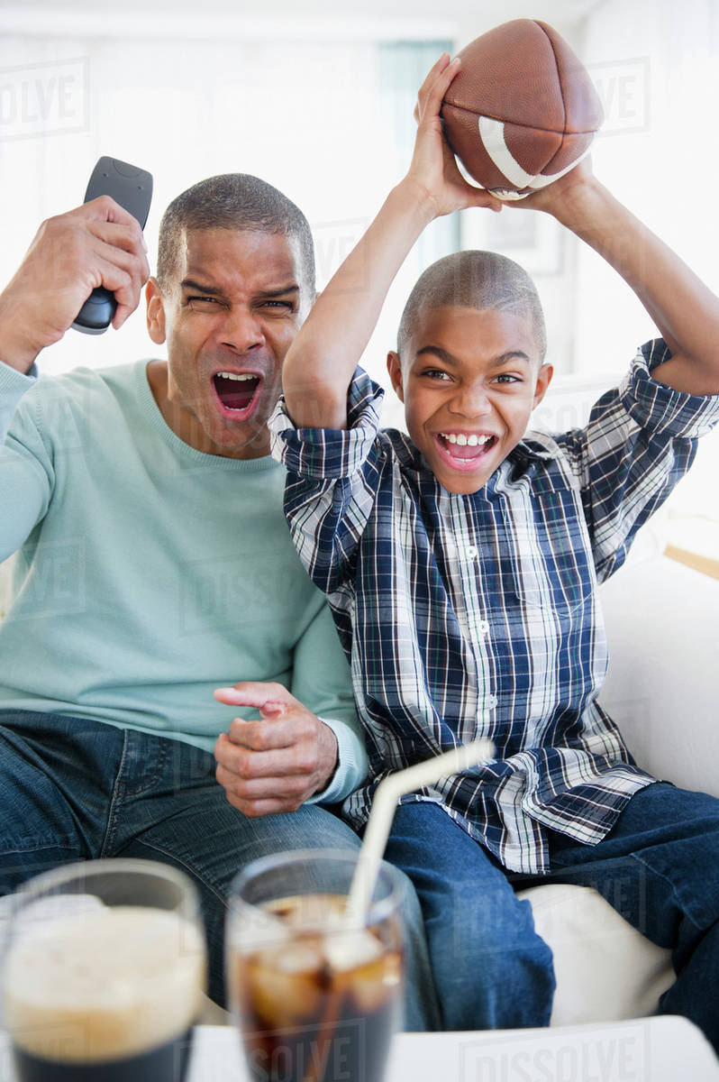 Father and son watching football on television - Royalty-free Stock ...