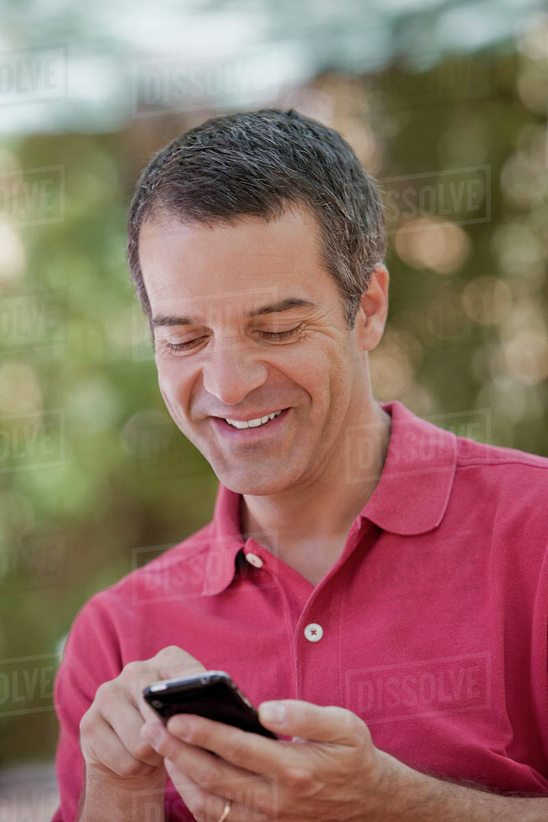 Hispanic man text messaging on cell phone - Royalty-free Stock Photo ...