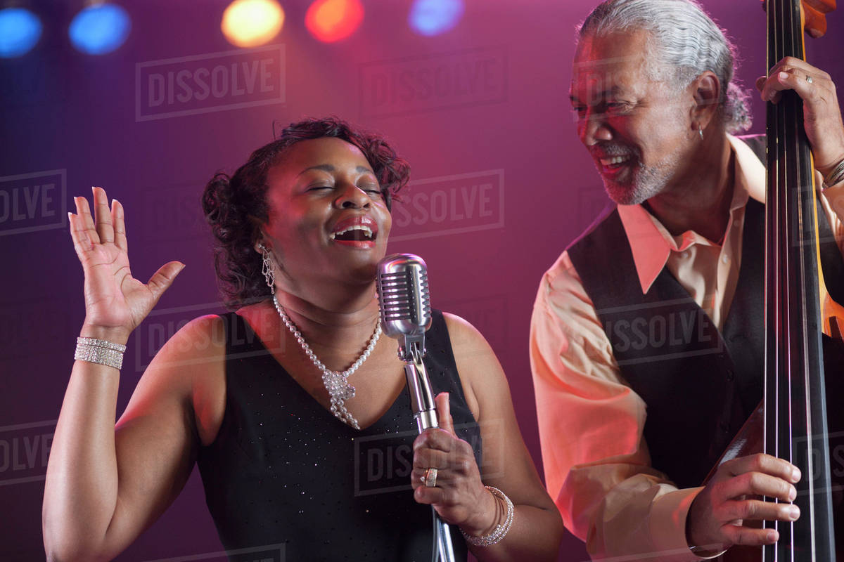 Black woman singing on stage with jazz band - Royalty-free Stock Photo ...