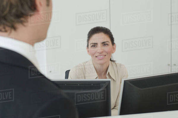 Hispanic businessman talking to receptionist - Royalty-free Stock Photo ...