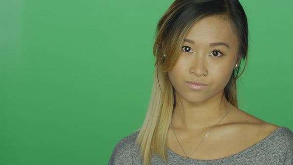 Cute girl glaring, on a green screen studio background - Stock Video ...