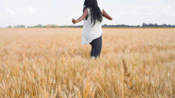 Black woman running through a wheat field - Stock Video Footage - Dissolve
