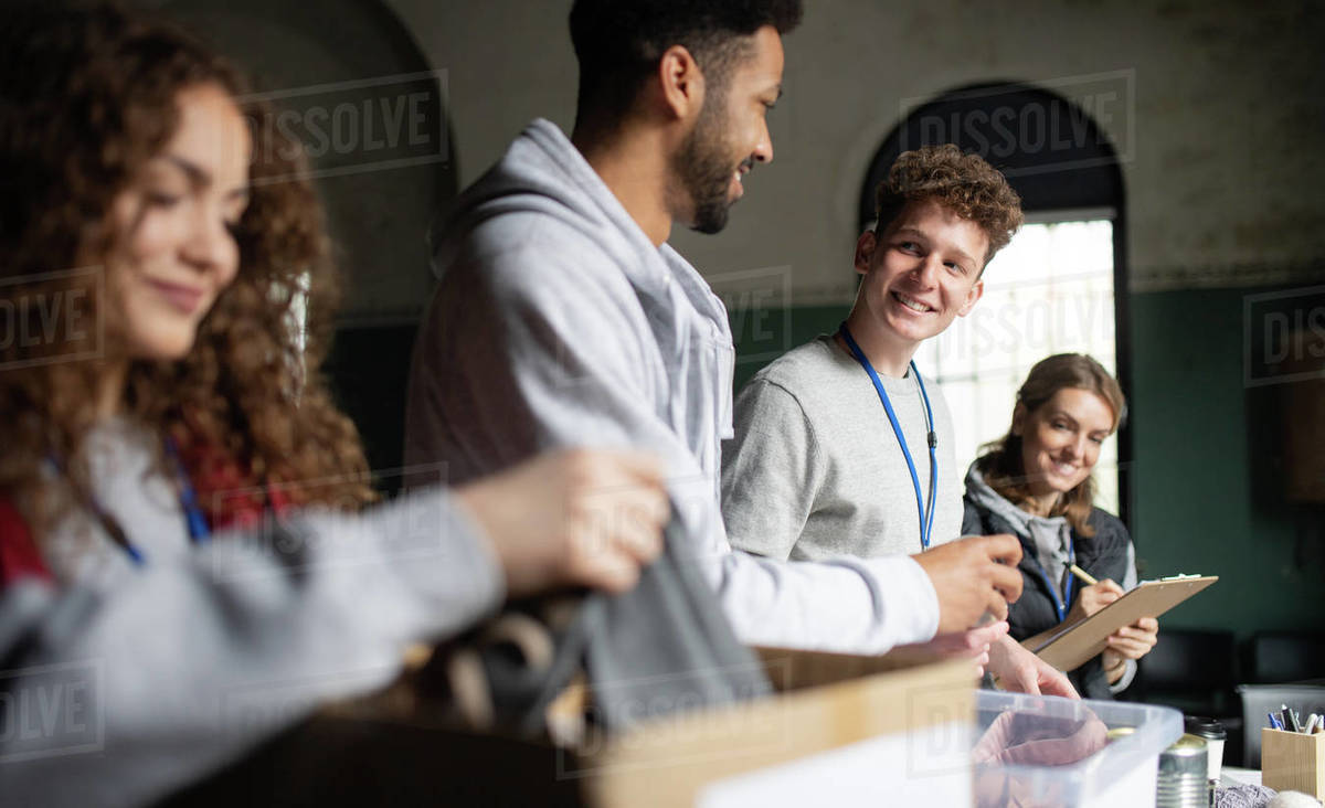 A group of volunteers working in community charity donation center ...