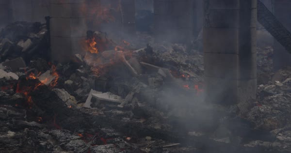 Close-up smoldering rubble of a burned structure - Stock Video Footage ...