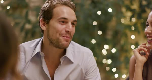 Four people, two couples happy talking eating and drinking during a ...