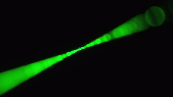 Green Laser Ray on a Black Background. Power laser beam shining through ...